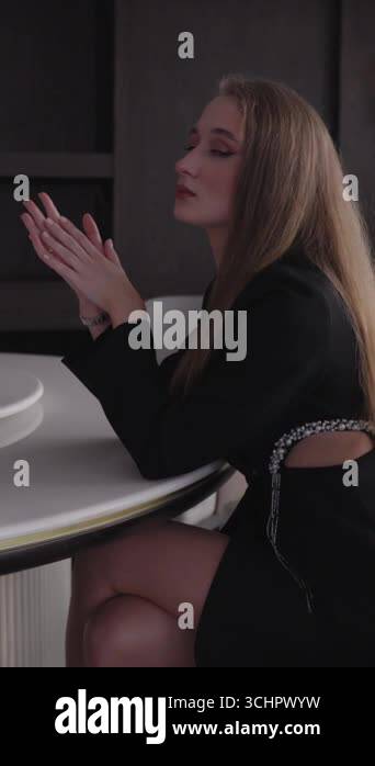 Professional businesswoman in sleek black dress sitting confidently at ...