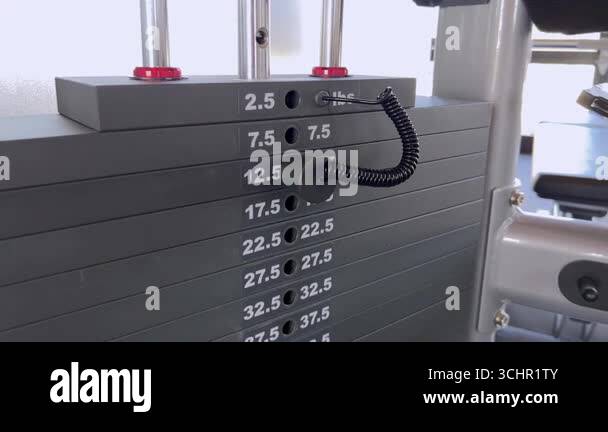 Side view of a weight stack on a gym machine with clearly labeled ...