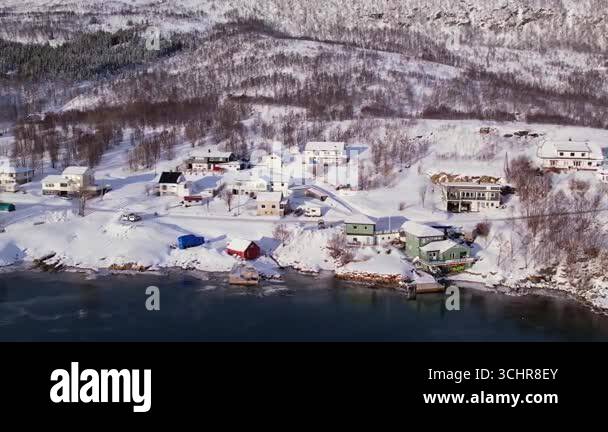 Snow covered mountain range on coastline in winter, Norway ...
