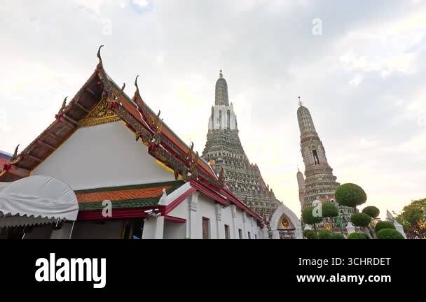 Tourists wander around Wat Arun temple in Bangkok, capturing its ...