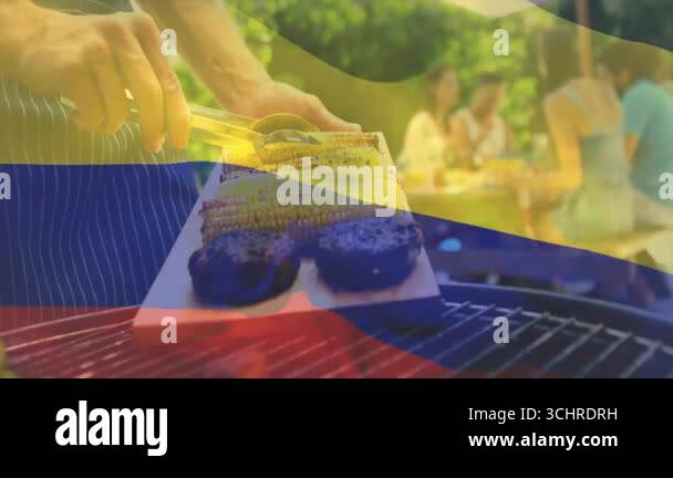 Host placing patties on grill rotating corn and serving board to ...