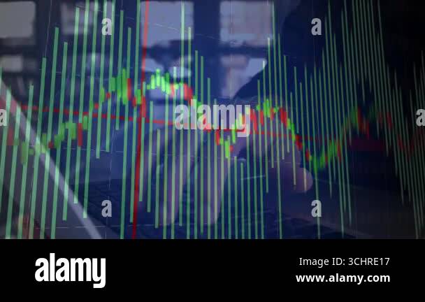 Financial analyst tapping smartphone and typing on laptop adjusting ...
