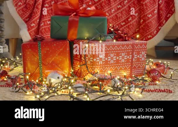 Close-up of Christmas presents in red and green wrapping with bows ...