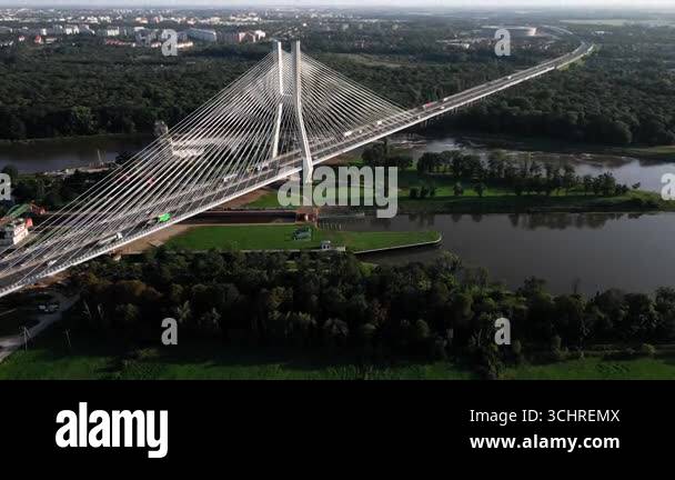 Aerial view of modern cable-stayed bridge over river with traffic and ...