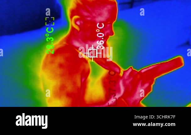 Thermographic imaging shows a womans body heat in red and yellow ...