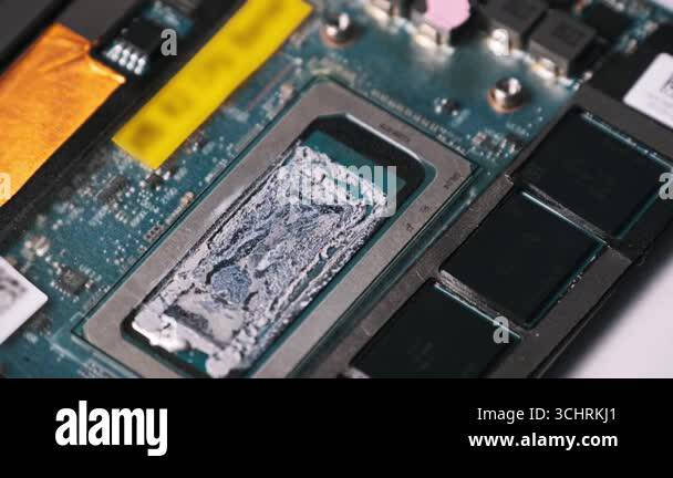 Angled close-up view of a central processing unit with unevenly applied ...