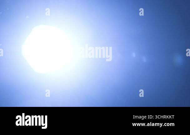 A hand holds a bright flashlight, pointing the beam directly at the ...
