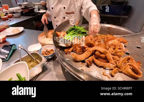 Chef assembling stewed pork leg rice meal Stock Video Footage - Alamy