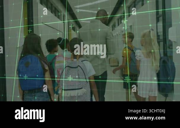 Male teacher guiding students in school hall, pointing toward classroom ...