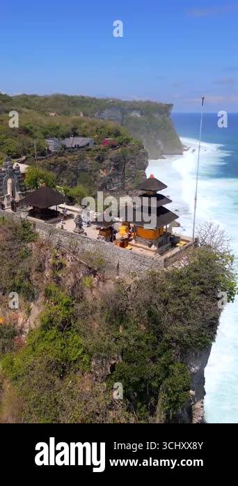 Aerial drone view of Uluwatu Temple on cliffs above the turquoise ocean ...