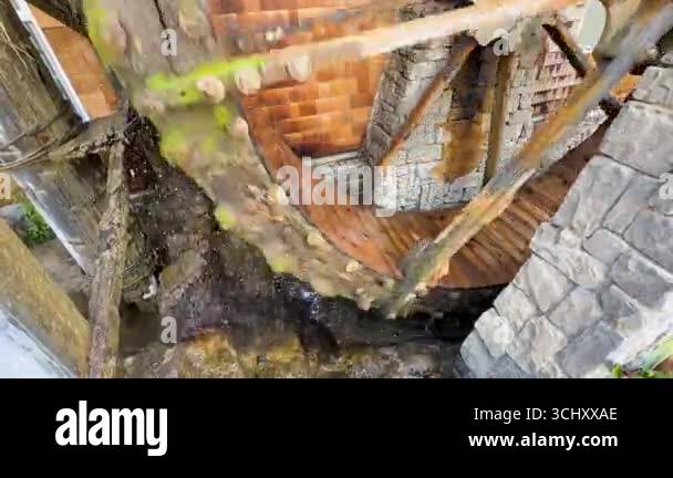 Rotating water mill. Old wooden water mill. Mill wheel rotating under ...