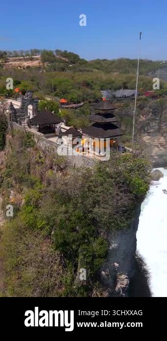 Aerial drone view of Uluwatu Temple on cliffs above the turquoise ocean ...