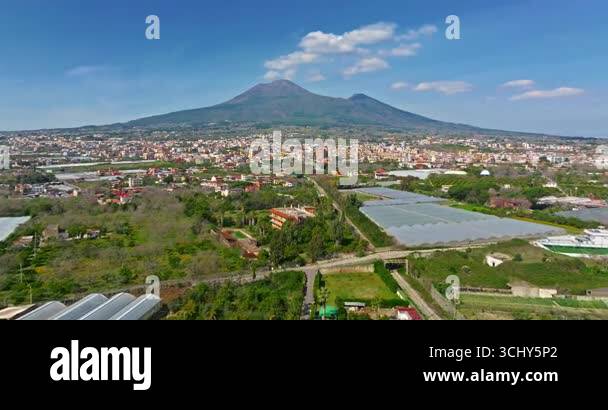 Aerial view of the city of Pompeii with the active volcano Vesuvius in ...