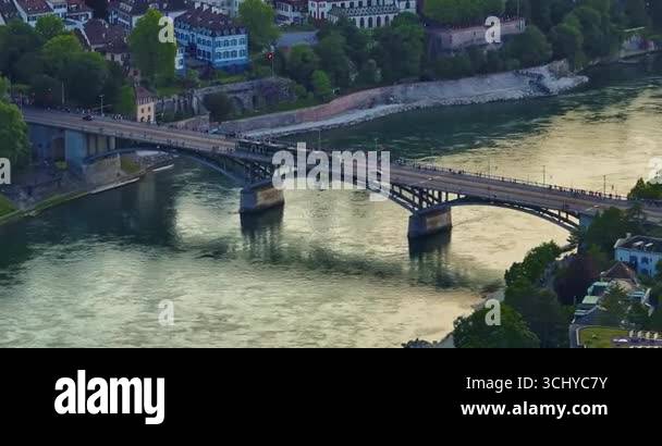 Aerial drone footage of the Basel old town along the Rhine river which ...