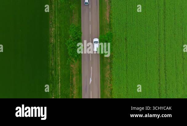 Aerial view Electric Car Driving on Country Road. Luxury modern vehicle riding fast along trees ...