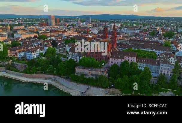 Aerial drone footage of the Basel old town along the Rhine river which ...
