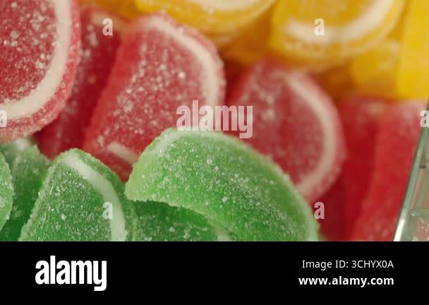 Brightly colored gummy candies stacked in a vibrant display Stock Video ...