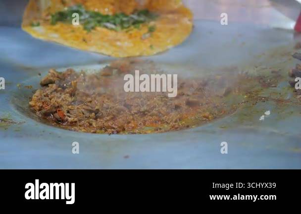 preparing street food on a hot griddle with meat and flatbread Stock ...