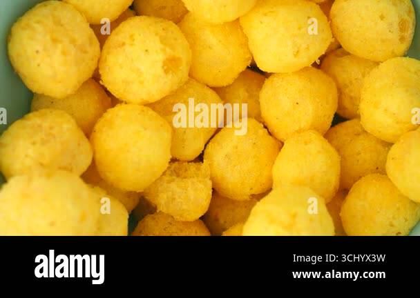 close-up of yellow puffed snacks.cheese balls or puffs Stock Video ...