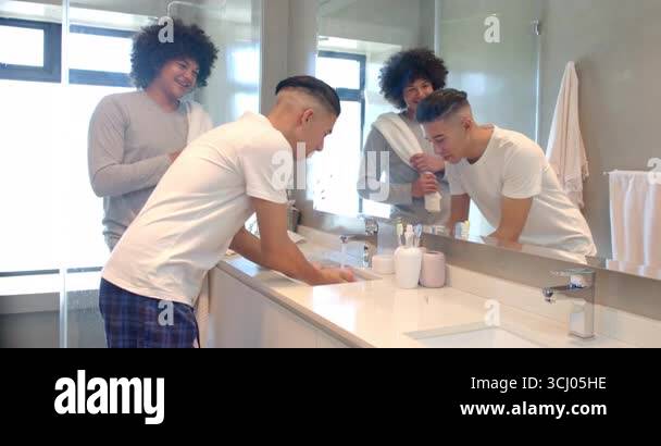 Diverse male friends grabbing toothbrush brushing teeth then sharing ...