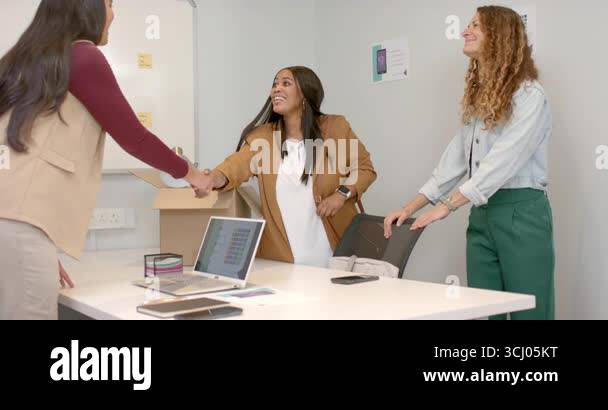 Entering office meeting room, Diverse female coworkers shaking hands at ...