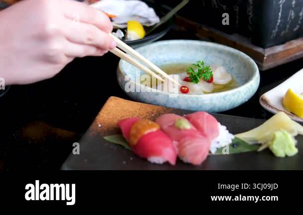 Korean-style sashimi is served with fresh herbs, hot sauce and garlic. Diners wrap slices of raw ...
