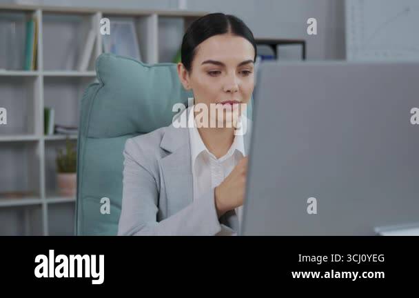 Businesswoman looks at the computer screen with fear of terrible news ...