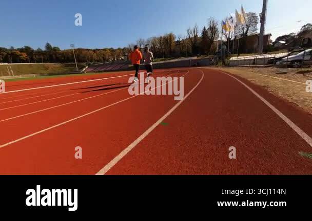 Young caucasian team sports running together performing intensive ...