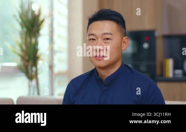 Smiling asian chinese man look at camera happy at home. Feel confident ...