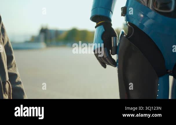 Close up hand child girl holds hand humanoid robot cyborg on street ...