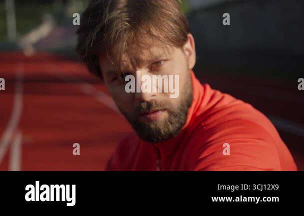 Attractive caucasian sports guy wearing sportswear posing for camera at ...