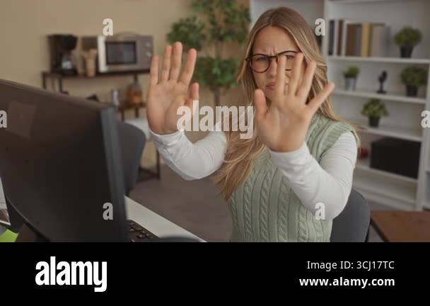 Woman with blonde hair wearing glasses hands raised with palms out at ...