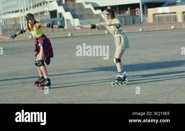 NEW YORK - October 5, 2020: Two young pretty girls rolling skating ...