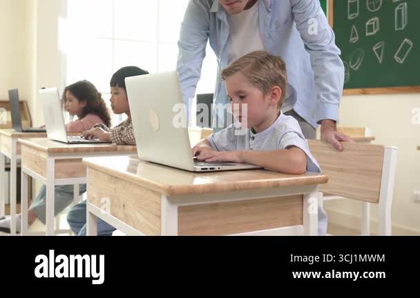 Caucasian teacher helping energetic boy coding engineering prompt while ...