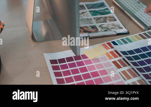 A vibrant workspace scene showcasing a hand selecting color swatches ...