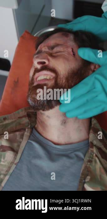 Hands medic provides medical care to a wounded military man lying ...