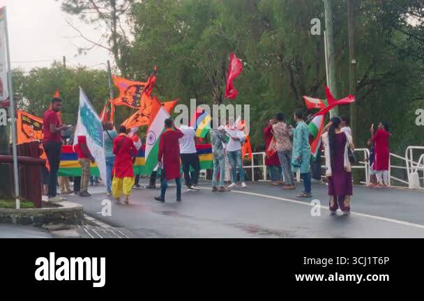 A colorful gathering features diverse flags and traditional attire in ...