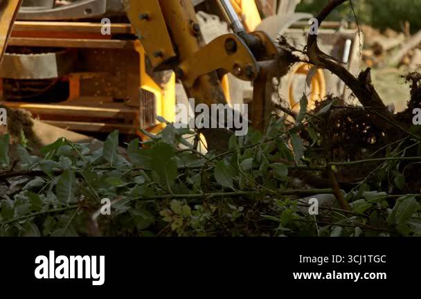 This video highlights heavy machinery at work, with a yellow tractor ...