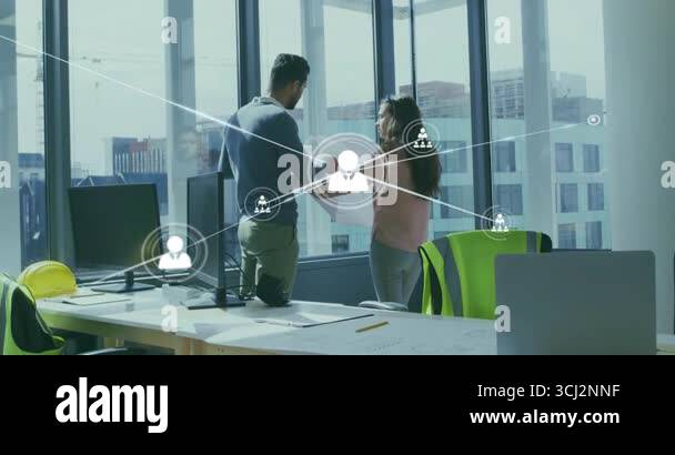 Office professionals discussing project by window sparking animated ...