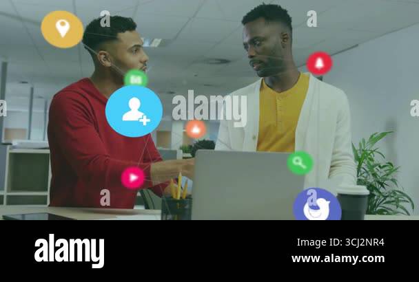 Pair reaching for pencil reviewing on laptop with animated media icons showing technology ...