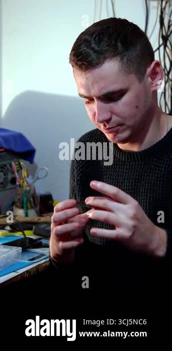 A Master Phone Technician at Work. A Vertical Close-up on a Smartphone ...