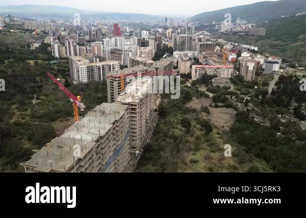 Tbilisi, Georgia - july, 10th, 2024: construction site with team of builders work together lay ...