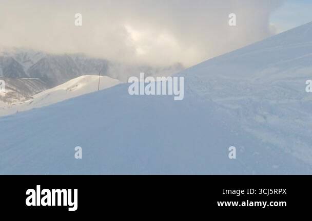 POV skier skiing hyperlapse in Tetnuldi ski resort downhill slope journey over snow-covered ...