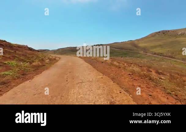 A beautiful, scenic pathway winding gently through lush green hills ...
