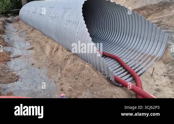 A corrugated iron tunnel will serve as a bridge over a stream under the ...