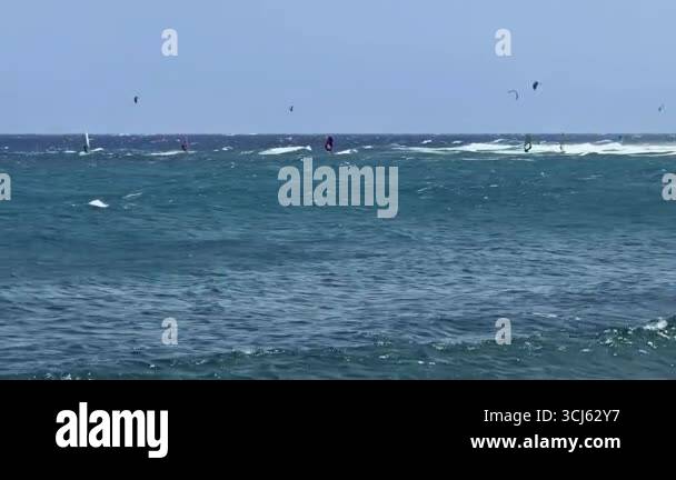 Immerse yourself in the exhilarating thrill of kitesurfing against the ...