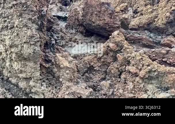 A closeup of rugged lava rock formations, highlighting unique textures ...