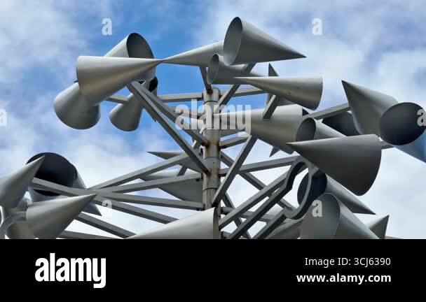 This striking artwork features a stunning wind sculpture of conical ...