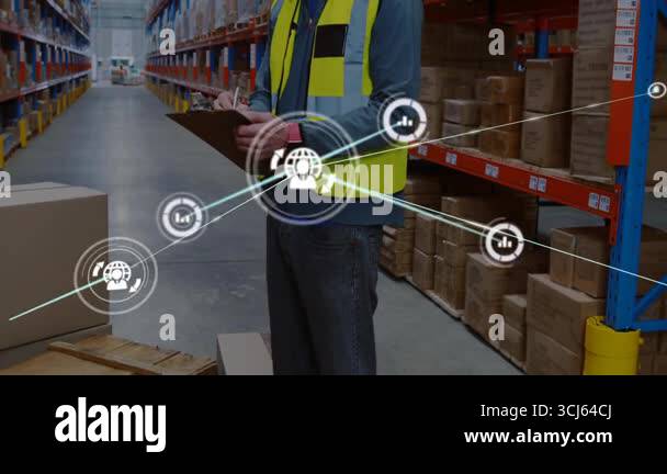 Warehouse worker glancing at clipboard and writing in aisle ...