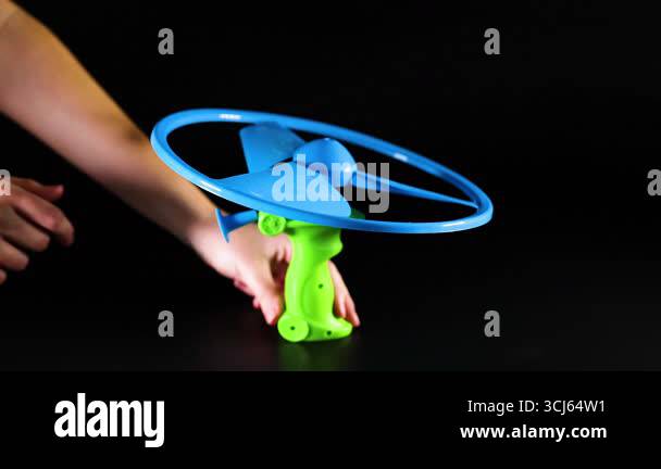 Hand launches toy helicopter using pull-string mechanism Stock Video ...
